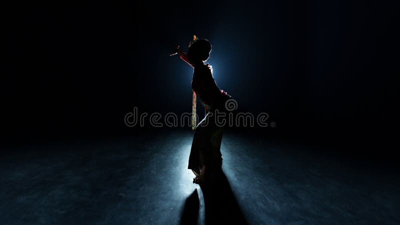 The Silhouette of a Female Dancer Shows the Contours of Her Body with ...