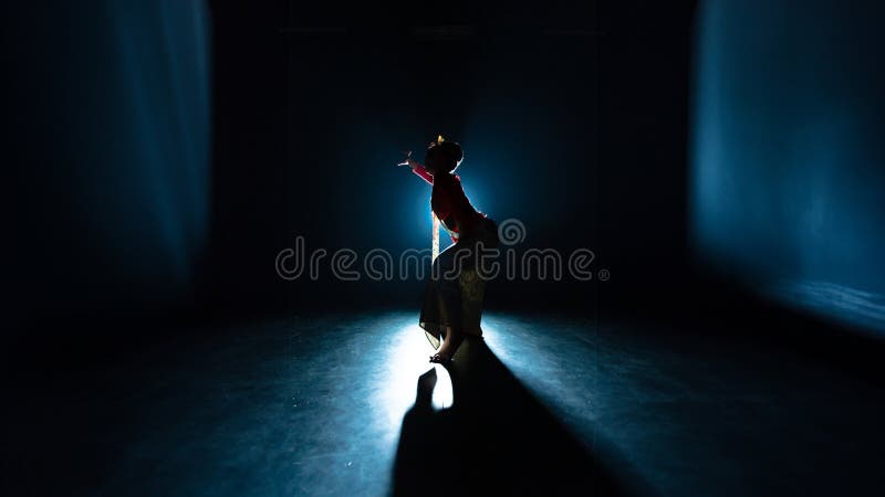 The Silhouette of a Female Dancer Shows the Contours of Her Body with ...