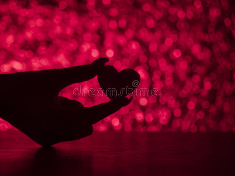 Silhouette of a Female Hand on a Table Holding Stock Photo - Image of ...