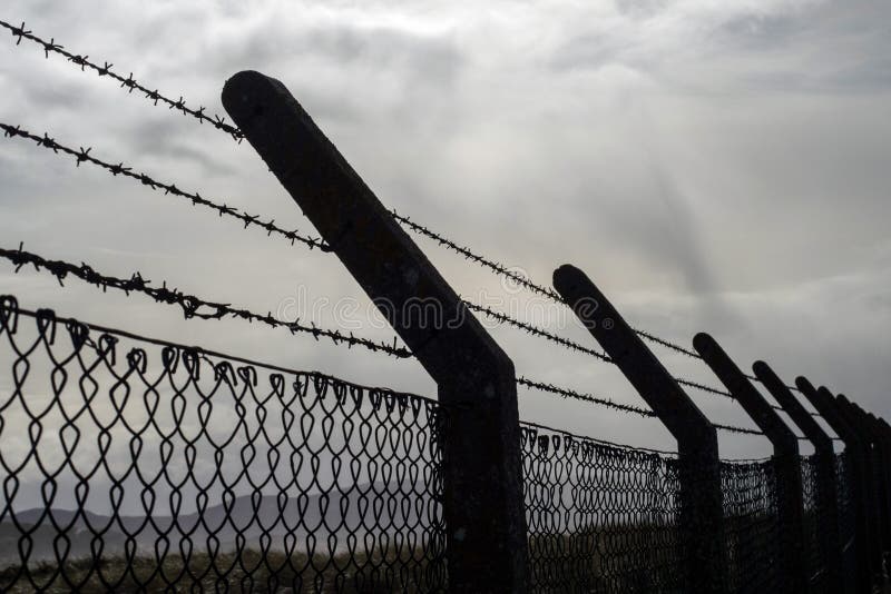 Silhouette of a Fence with Barbered Wire on Top, Concept Prison ...