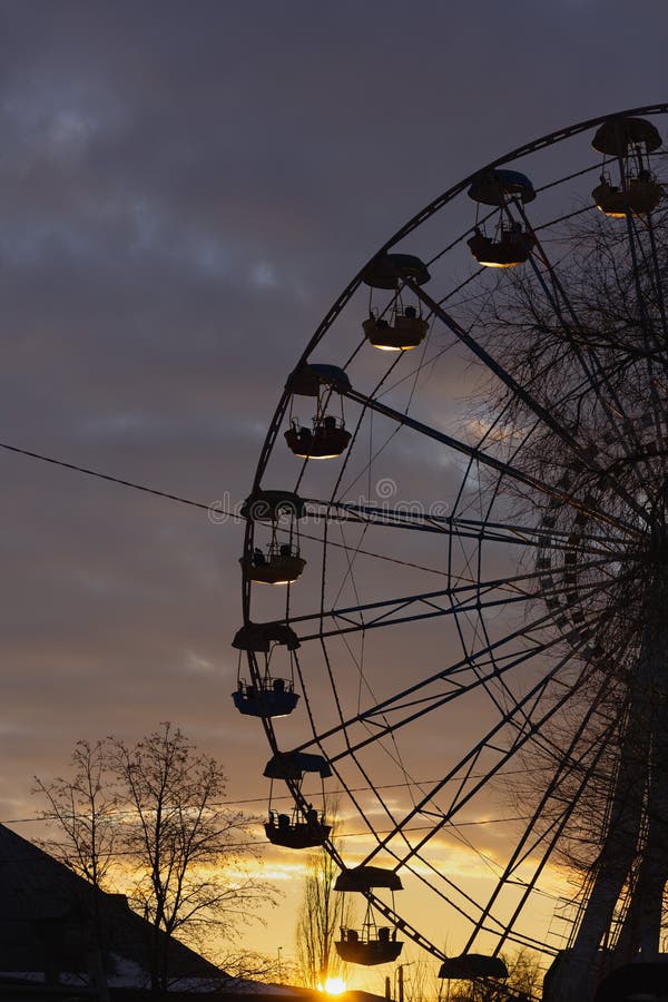 A Silhouette of a Ferring Wheel. Cubs Lit from the Bottom from the ...