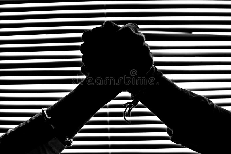 Silhouette Figures in Monochrome of Hands Against a Light and Shadow ...