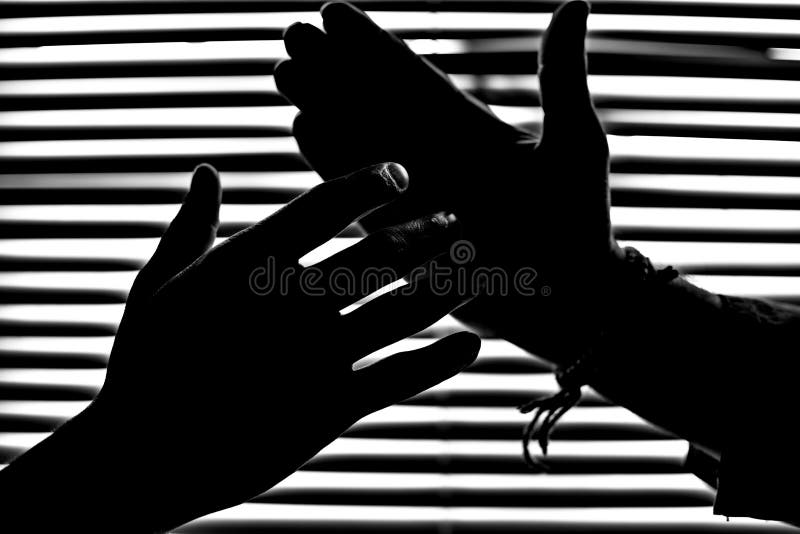 Silhouette Figures in Monochrome of Hands Against a Light and Shadow ...