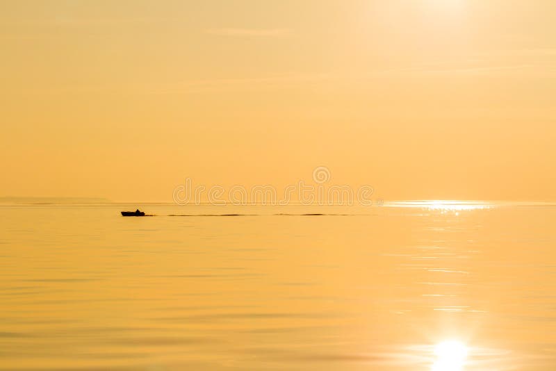 Silhouette of a Fishing Boat in the Sea. Quiet Beautiful Golden Sunset ... Silhouette of a Fishing Boat in the Sea. Quiet Beautiful Golden Sunset ...