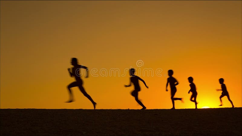 Silhouette of Five Kids Jumping Against Sunset Stock Video - Video of ...