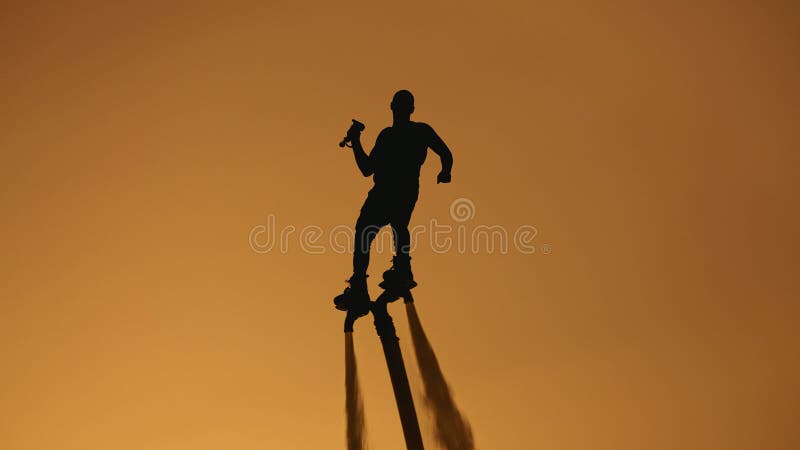 Silhouette of a Flyboarder on the Background of the Sunset Sky. Athlete ...