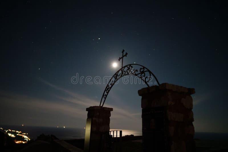 Silhouette of a Gate Entrance with a Cross on Top in the Nighttime ...