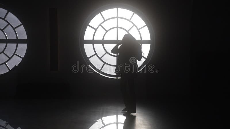 Silhouette of a Girl Against the Background of a Round Window. Stock ...