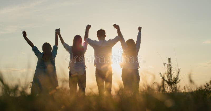 Silhouette of a Group of Friends - Raise Their Hands Up Against the ...