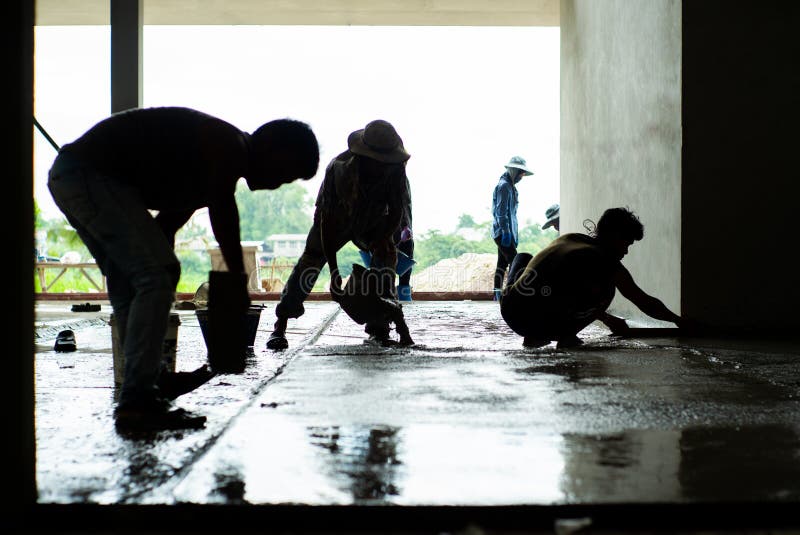 Silhouette Group of Workers Build the Cement Floor in the House Under ...