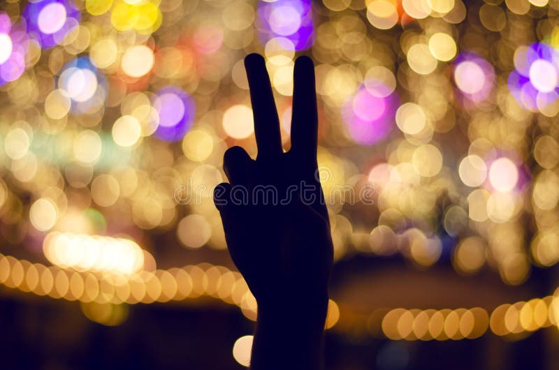 The Silhouette of a Hand on the Background of Bright Lights. Decorated ...