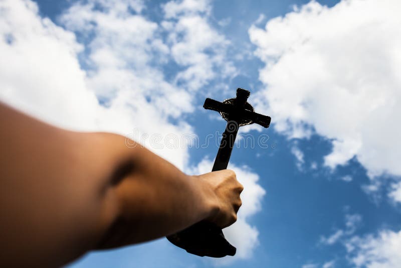 Silhouette of Hand Holding Cross in the Sky, Focus at the Cross Stock ...