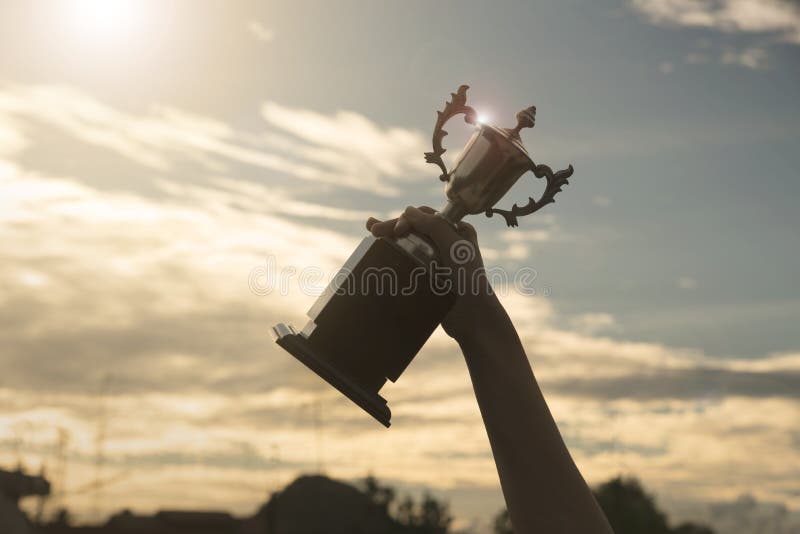 Silhouette Hand Holding Winner Trophy Cup in a Championship Stock Image ...