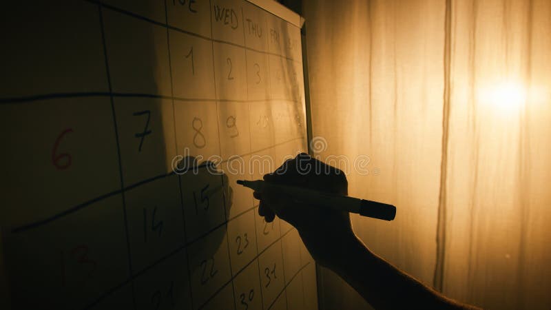 Silhouette of Hand Marking Date on the Calendar Stock Photo - Image of ...