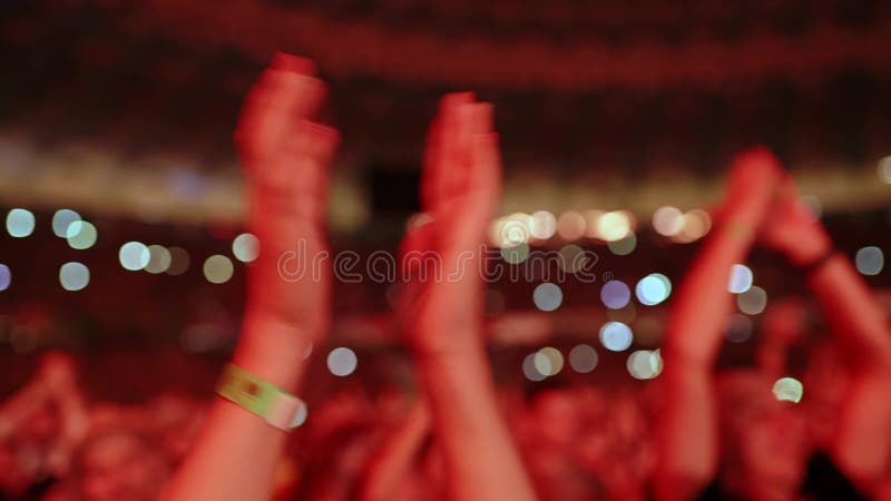 Cheering Hands at a Concert in Front of a Large Stage in the Spotlight ...
