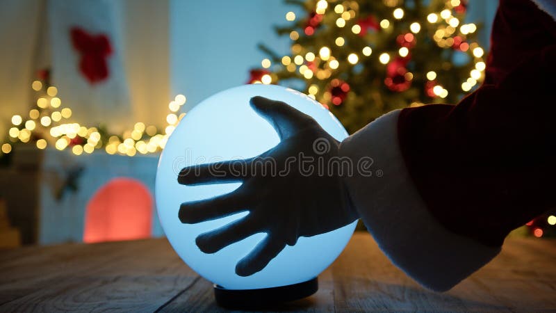 Silhouette Hands of Santa Claus Make Magic of a Light Ball during ...