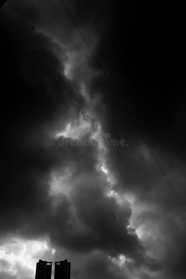 Silhouette of a High Rise Skyscraper with Dark Dramatic Monsoon Clouds ...