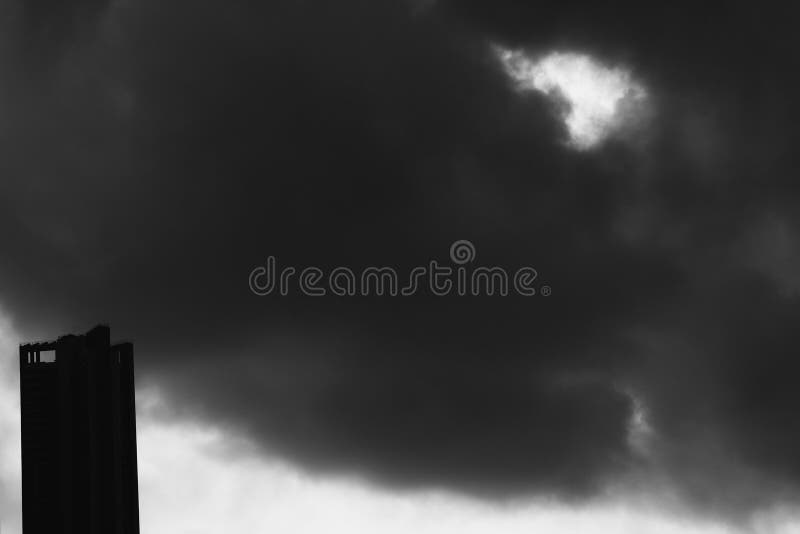 Silhouette of a High Rise Skyscraper with Dark Dramatic Monsoon Clouds ...