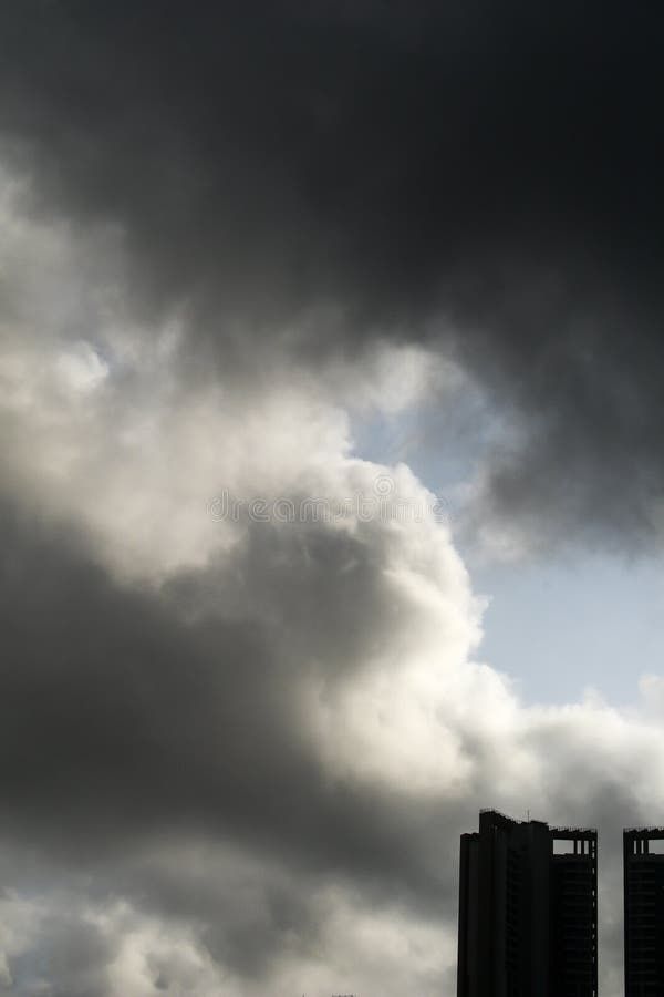 Silhouette of a High Rise Skyscraper with Dark Dramatic Monsoon Clouds ...