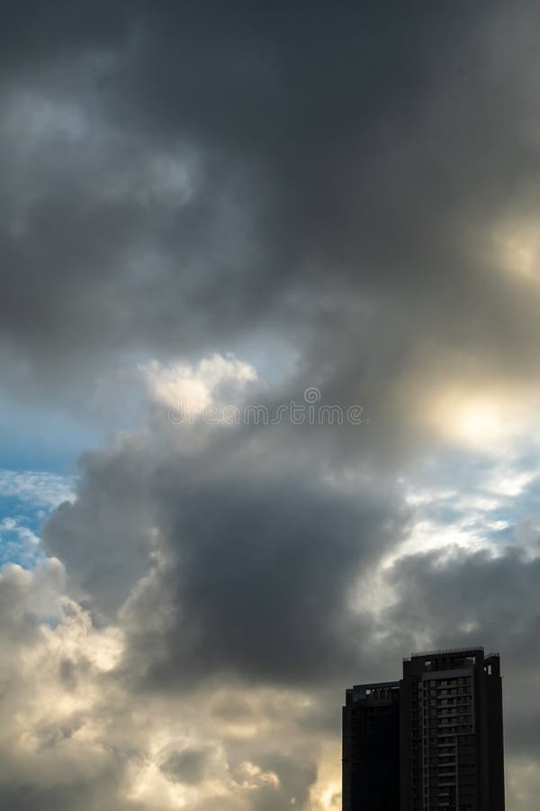 Silhouette of a High Rise Skyscraper with Dark Dramatic Monsoon Clouds ...