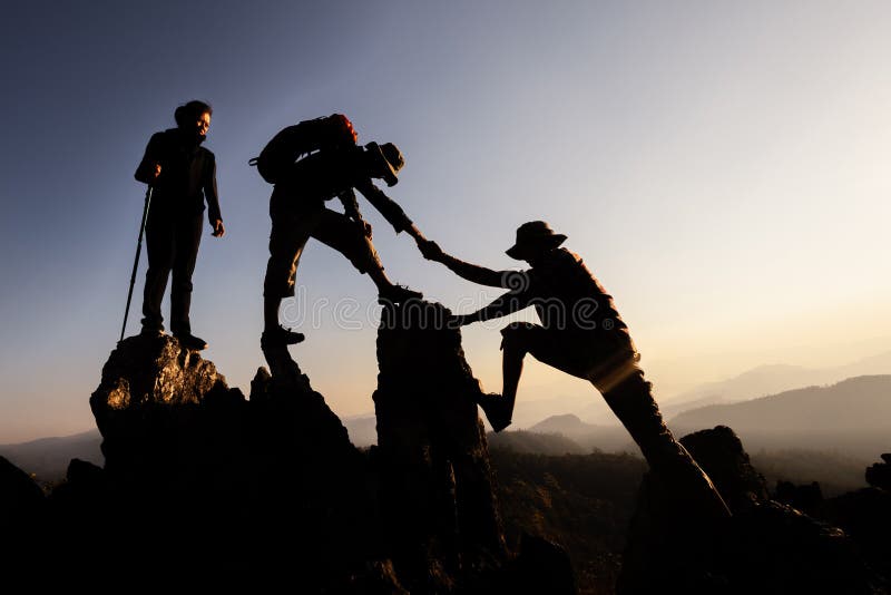 Silhouette of Hikers Climbing Up Mountain Cliff. Climbing Group Helping ...