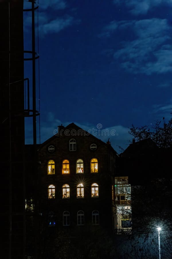 Silhouette of a House with Illuminated Windows on a Moonlit Night Stock ...