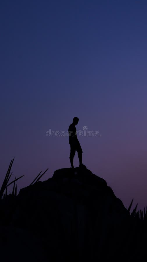Silhouette of Human Standing on Rock during Sunset Stock Image - Image ...