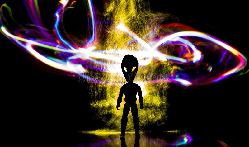Silhouette of a Humanoid with an Alien Head Surrounded by Colored ...
