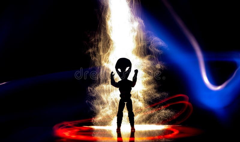 Silhouette of a Humanoid with an Alien Head Surrounded by Colored ...