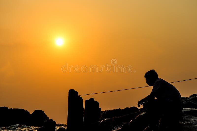 The Silhouette Image of a Lonely Sad Boy Sitting on a Rock Stock Photo ...