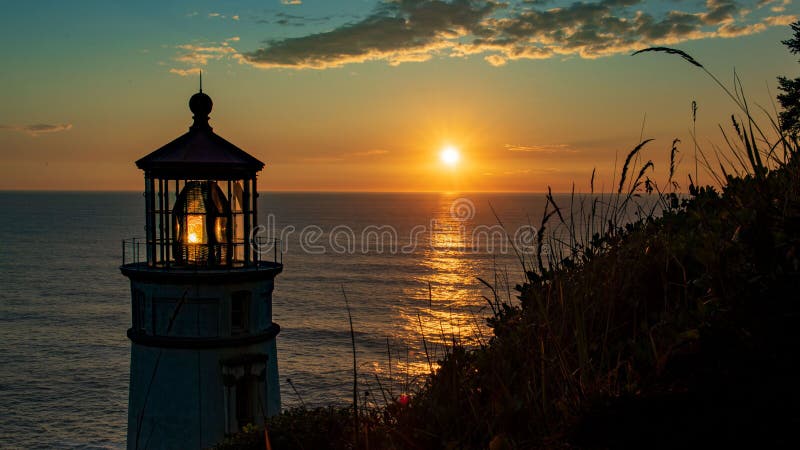 Silhouette of a Lighthouse by a Beach during the Sunset Stock Image ...