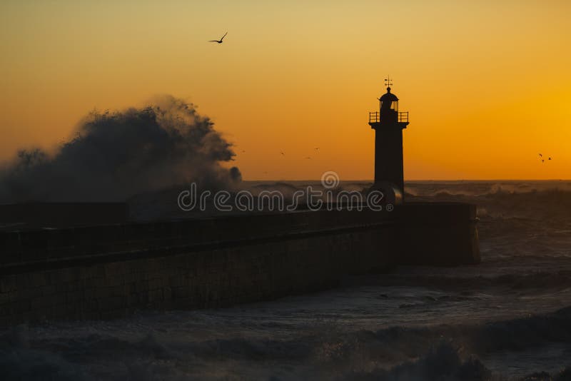 The Silhouette of a Lighthouse Being Washed by a Huge Wave during ...