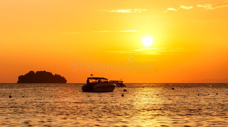 Silhouette of a Little Island and Small Boat at Sunset Stock Photo ...
