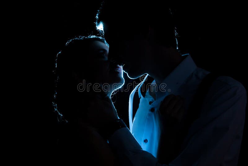 Silhouette of Loving Couple with a Blue Light Behind Stock Photo ...