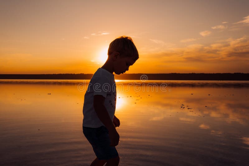 Silhouette of Male Child in Sunlight Rays. Stock Photo - Image of ...