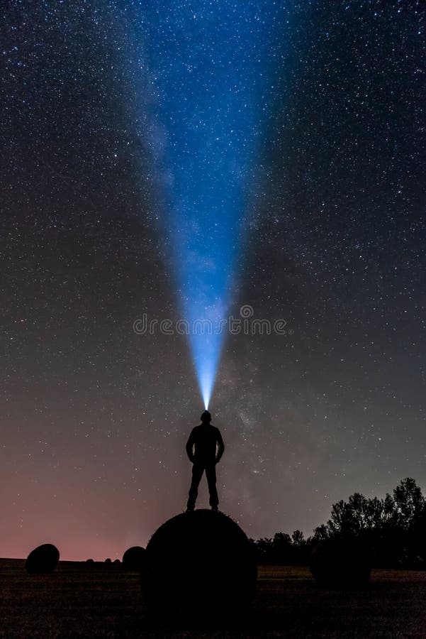 Silhouette of a Male with a Ray of Light from the Flashlight Standing ...