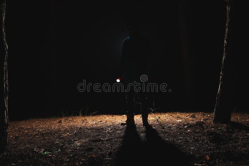 Silhouette of Man with Bright Flashlight in Forest Stock Photo - Image ...