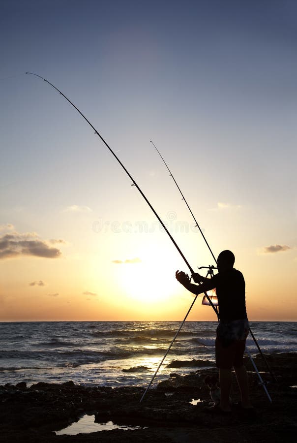 Silhouette of Man Fishing at Sunset Stock Image - Image of outdoor ...
