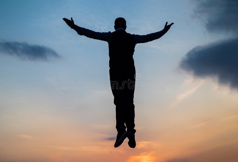 Silhouette of Man Float in Sunrise Sky with Raised Hands, Freedom Stock ...