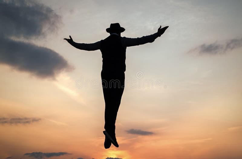 Silhouette of Man Float in Sunrise Sky with Raised Hands, Freedom Stock ...