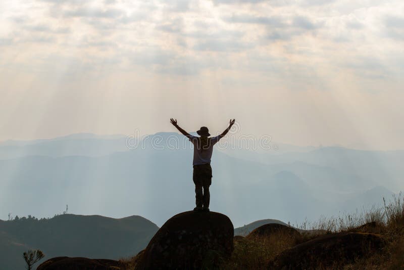 Silhouette of Man Hold Up Hands on the Peak of Mountain,success Concept ...