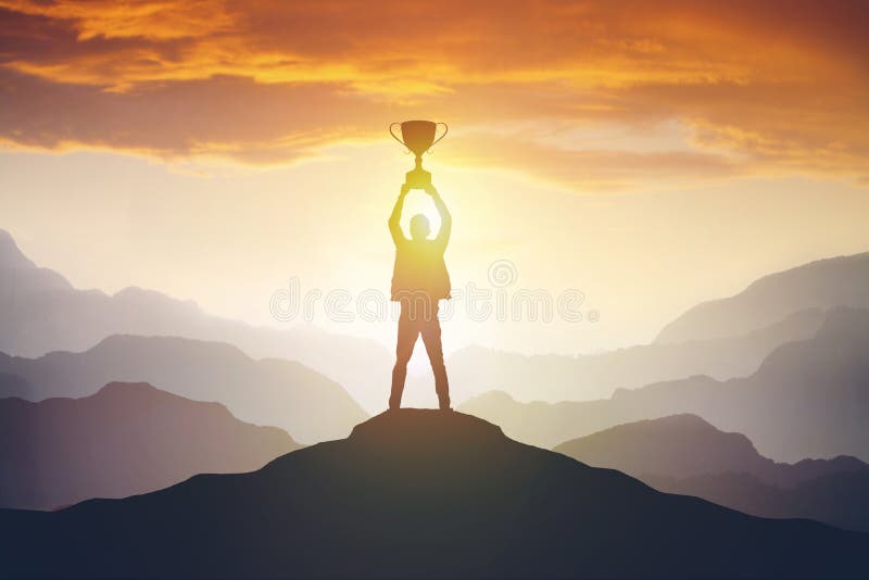 Silhouette of a Man Holding a Trophy at Sunset Stock Photo - Image of ...