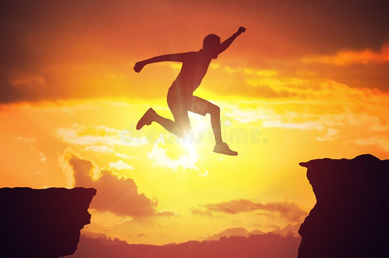 Silhouette of Man Jumping Over a Gap at Sunset Stock Photo - Image of ...