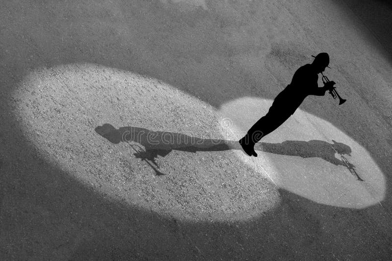 Silhouette of a Man Playing on a Trumpet, in the Spotlight with Shadow ...