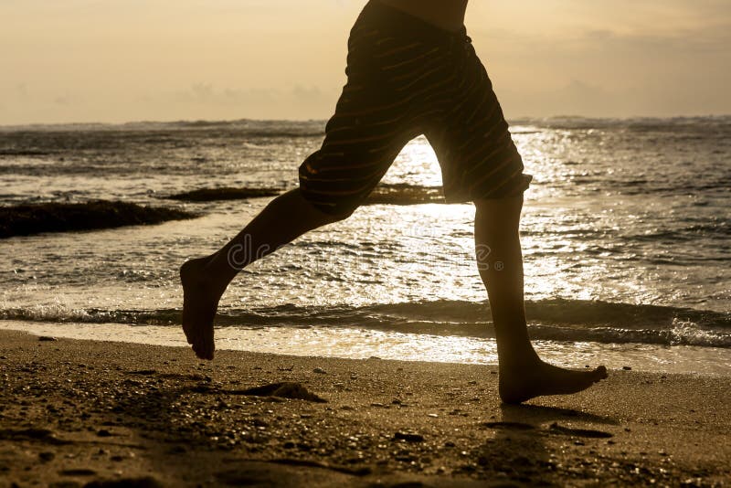 Silhouette of Man Running Along Shore of Ocean Stock Image - Image of ...