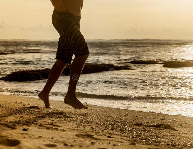 Silhouette of Man Running Along Shore of Ocean Stock Photo - Image of ...