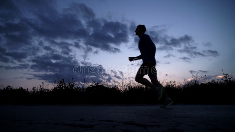 Silhouette of a Man Running on the Road at Sunset Stock Footage - Video ...
