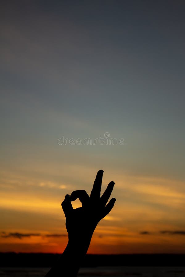 Silhouette of a Man`s Hand during Sunset Making the OK Symbol Stock ...