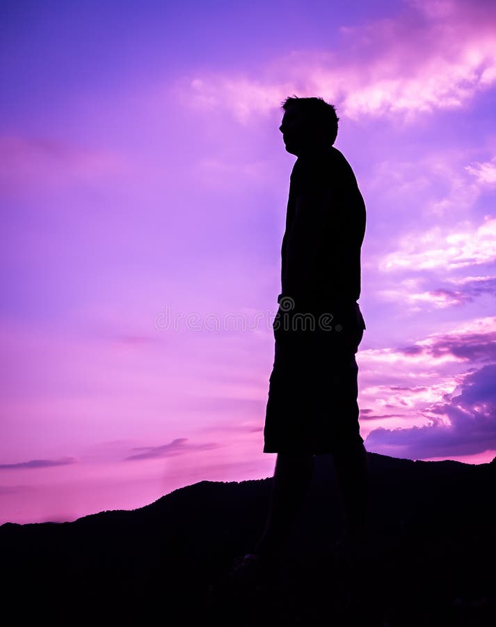 Person Standing Alone On Mountain