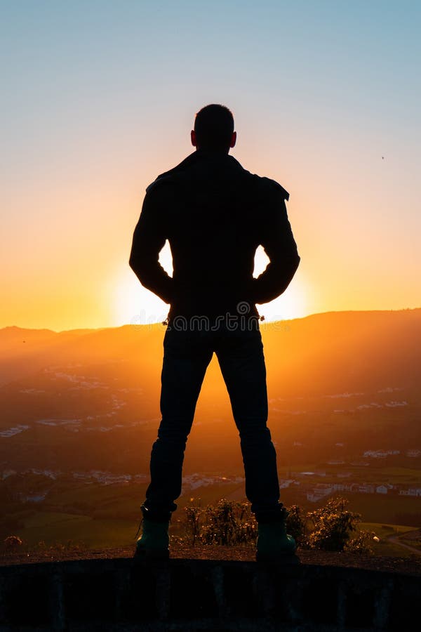 Person Standing Alone On Mountain